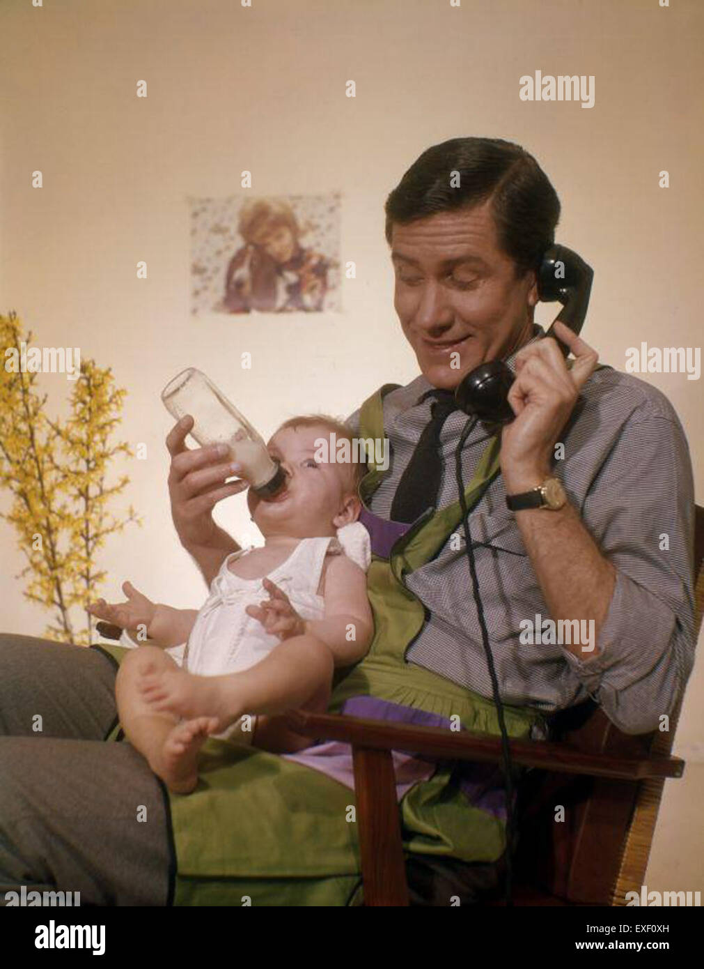 A tender photograph of a father feeding a baby, capturing a moment of ...