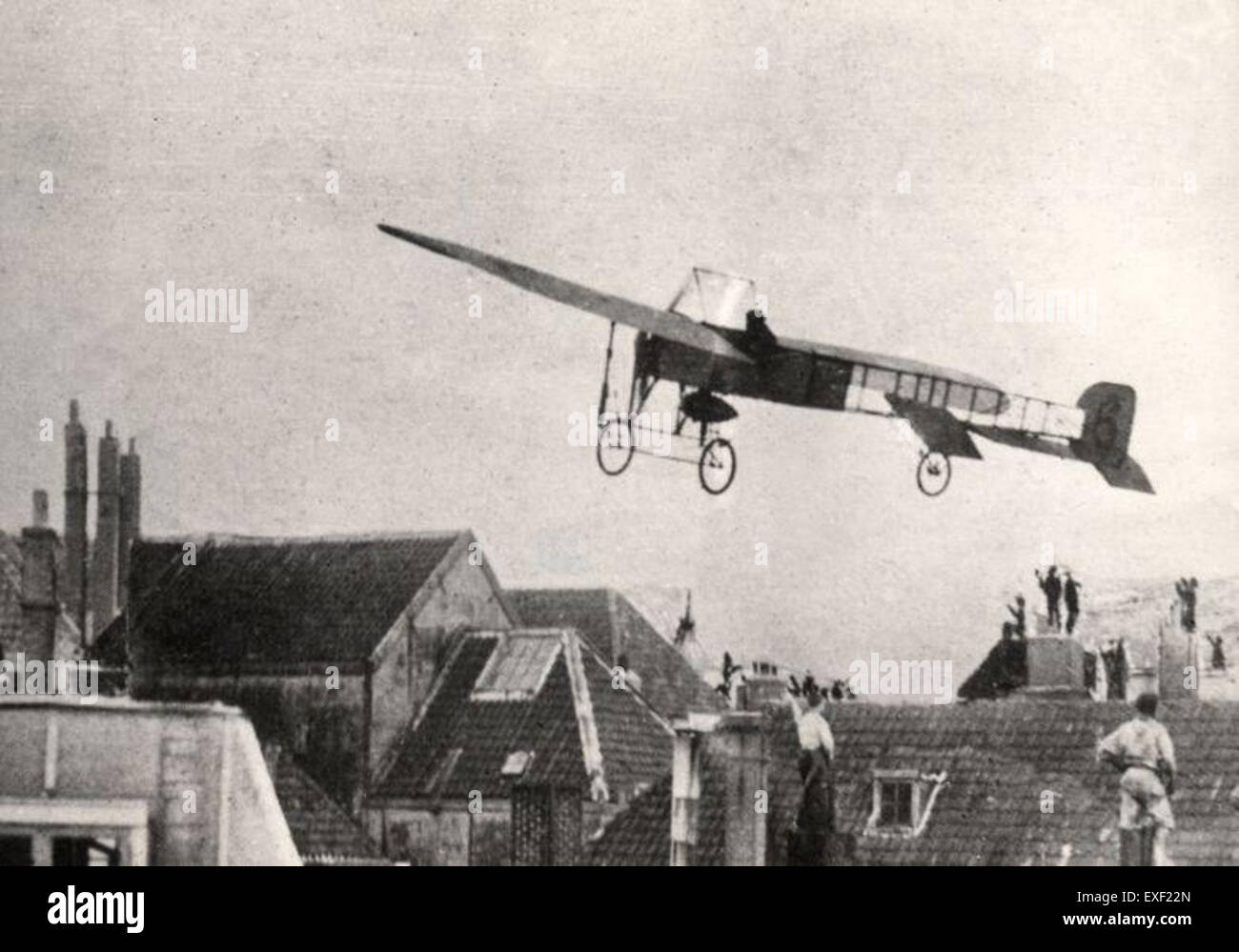 This early 20th-century image captures one of the first airplanes ...