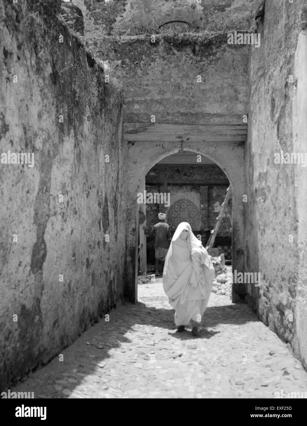 A portrait of a veiled woman in Tangier, Morocco, depicting the ...