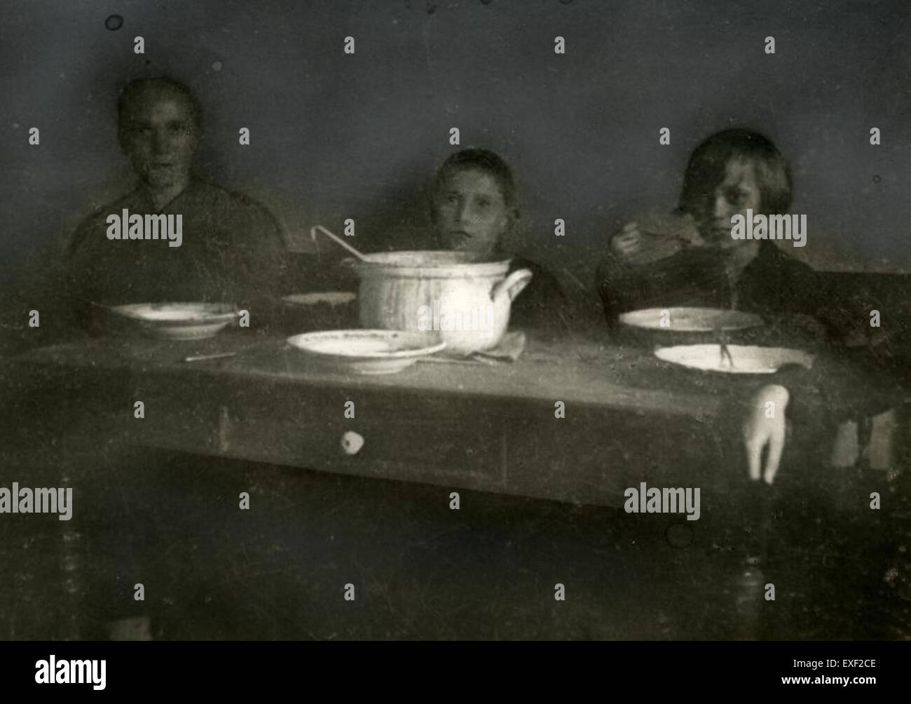This painting depicts a poor miners' family seated at a meal, capturing ...