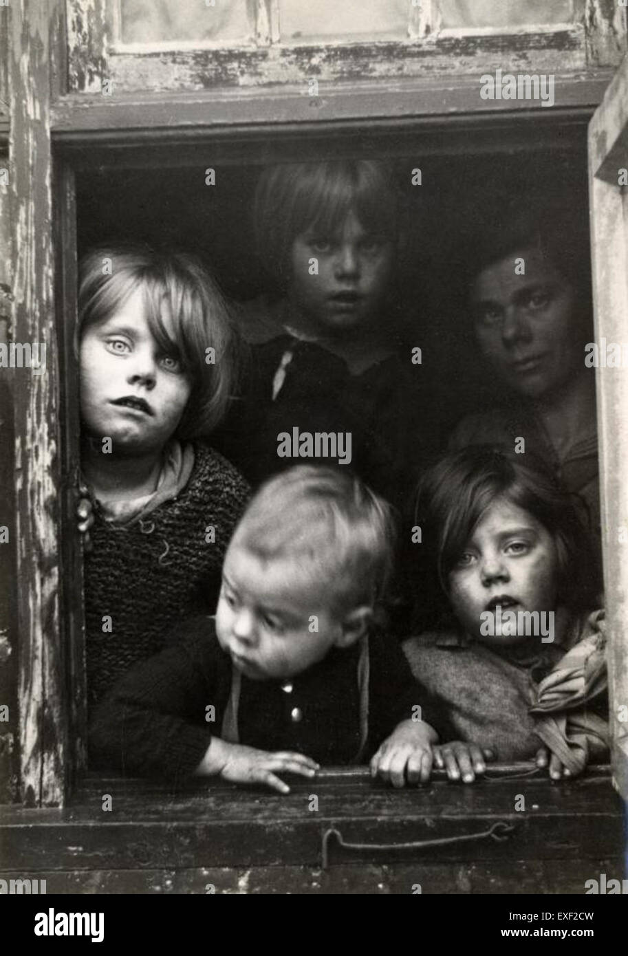 This image depicts poor children looking through a window, illustrating ...