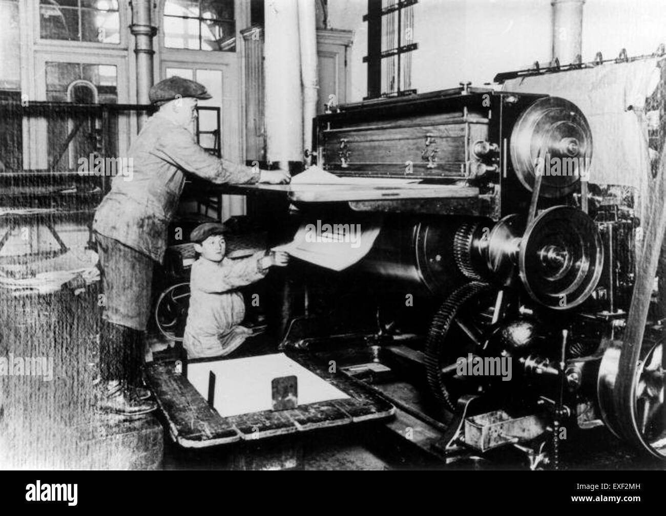 This historical photograph depicts child labor in a printing company ...