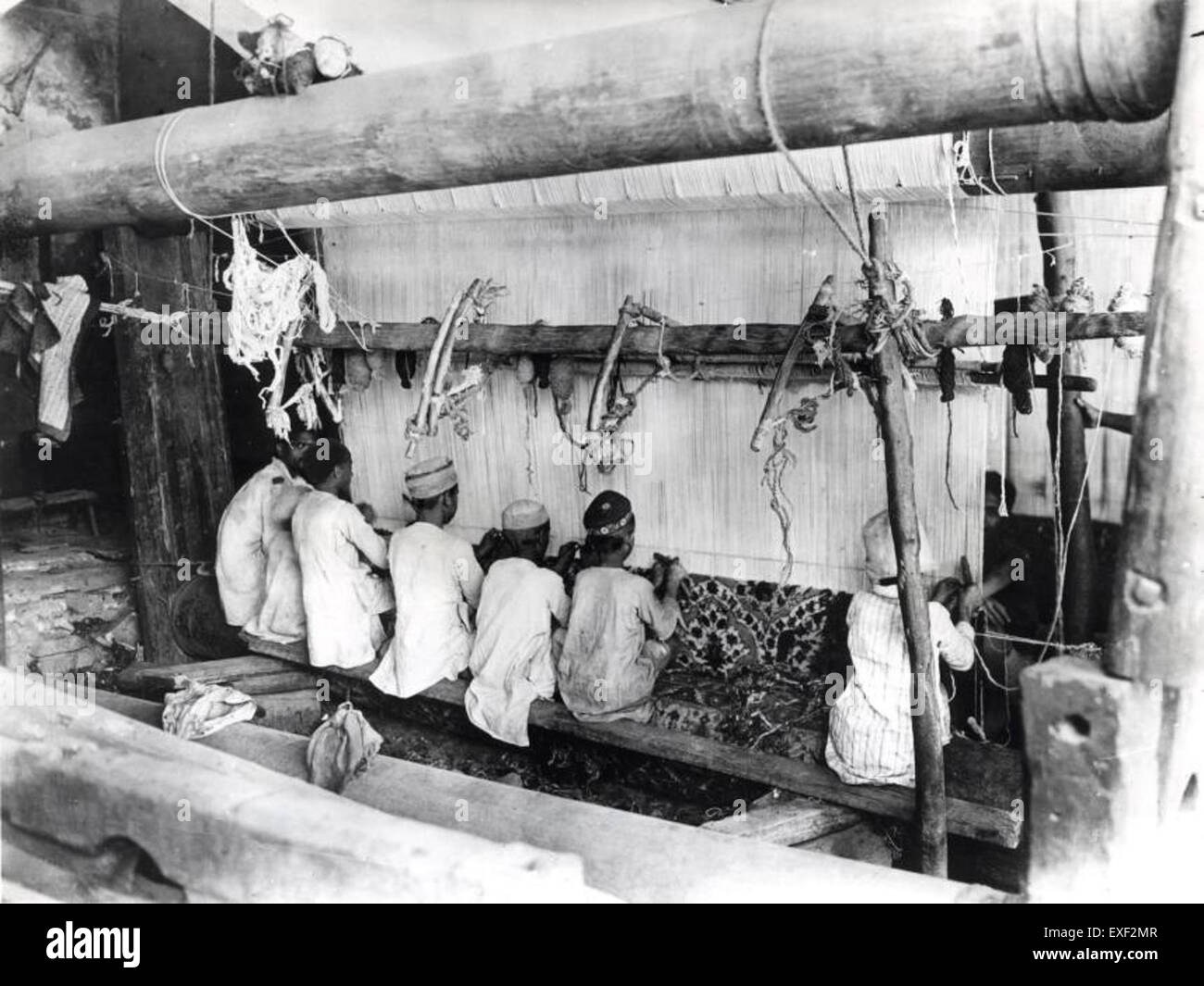 The artwork depicts boys engaged in the intricate process of knotting a ...