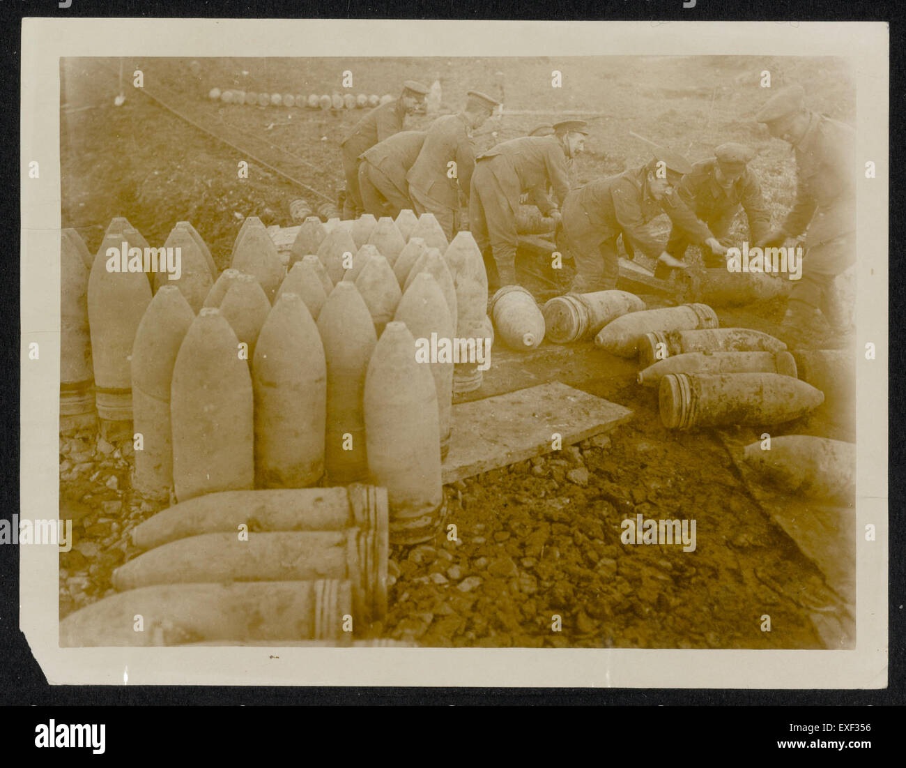 This photograph captures the process of loading shells onto a trolley ...