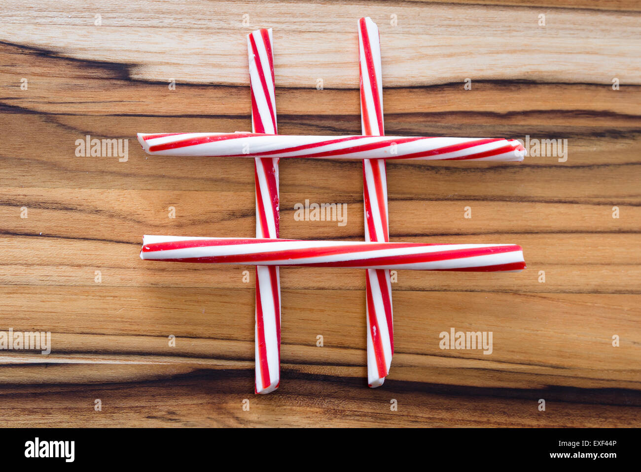 holiday background with stripped peppermint sticks on a wooden ...