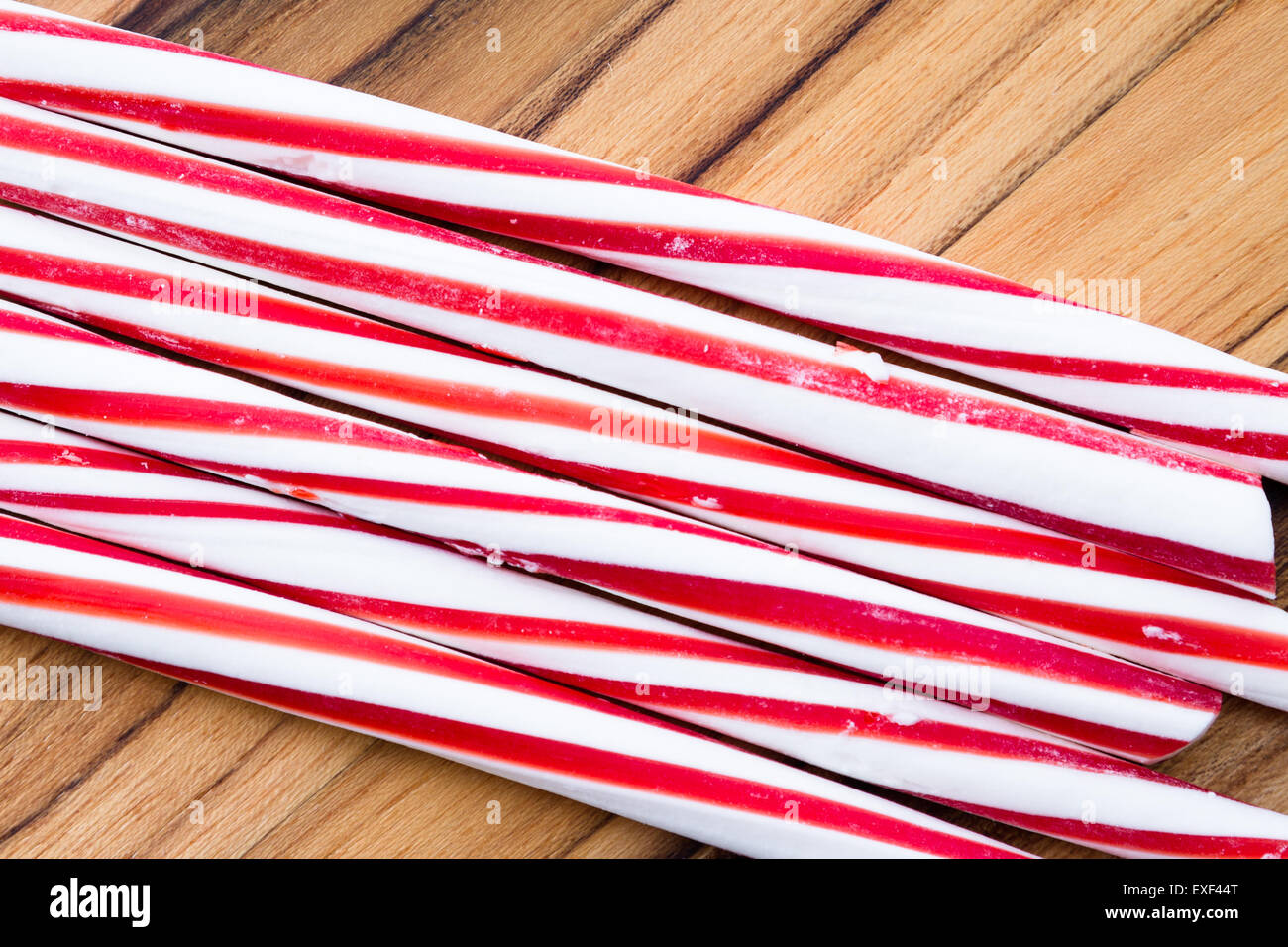 holiday background with stripped peppermint sticks on a wooden ...