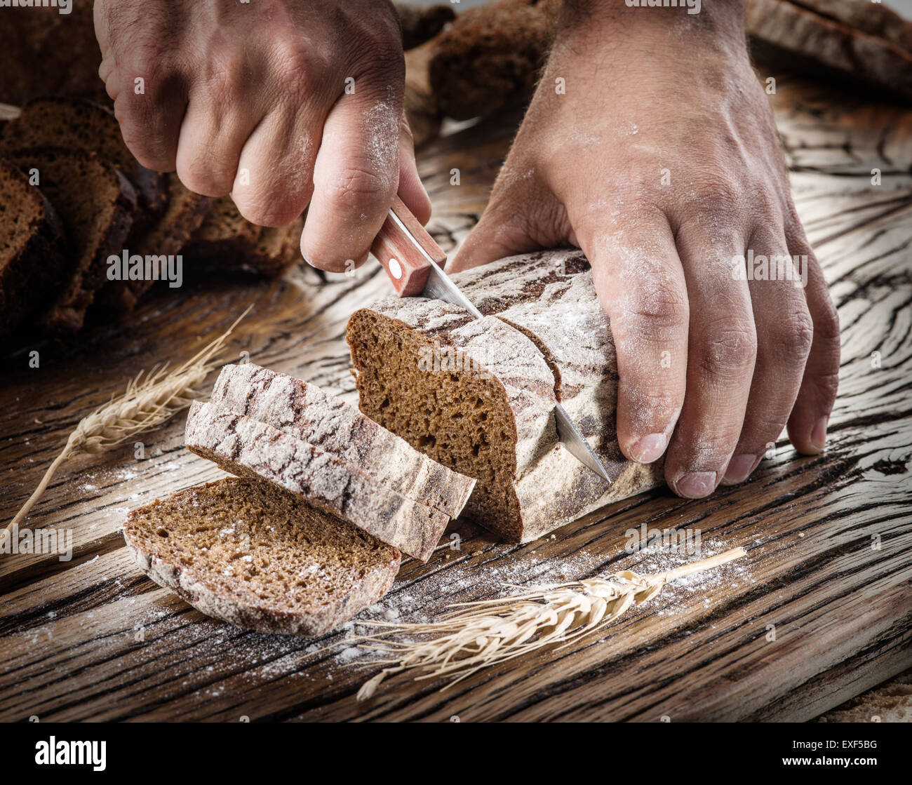 Hands cutting bread hi-res stock photography and images - Alamy