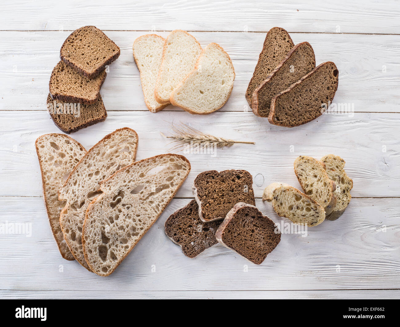 Different types of sliced bread on wooden table Stock Photo - Alamy