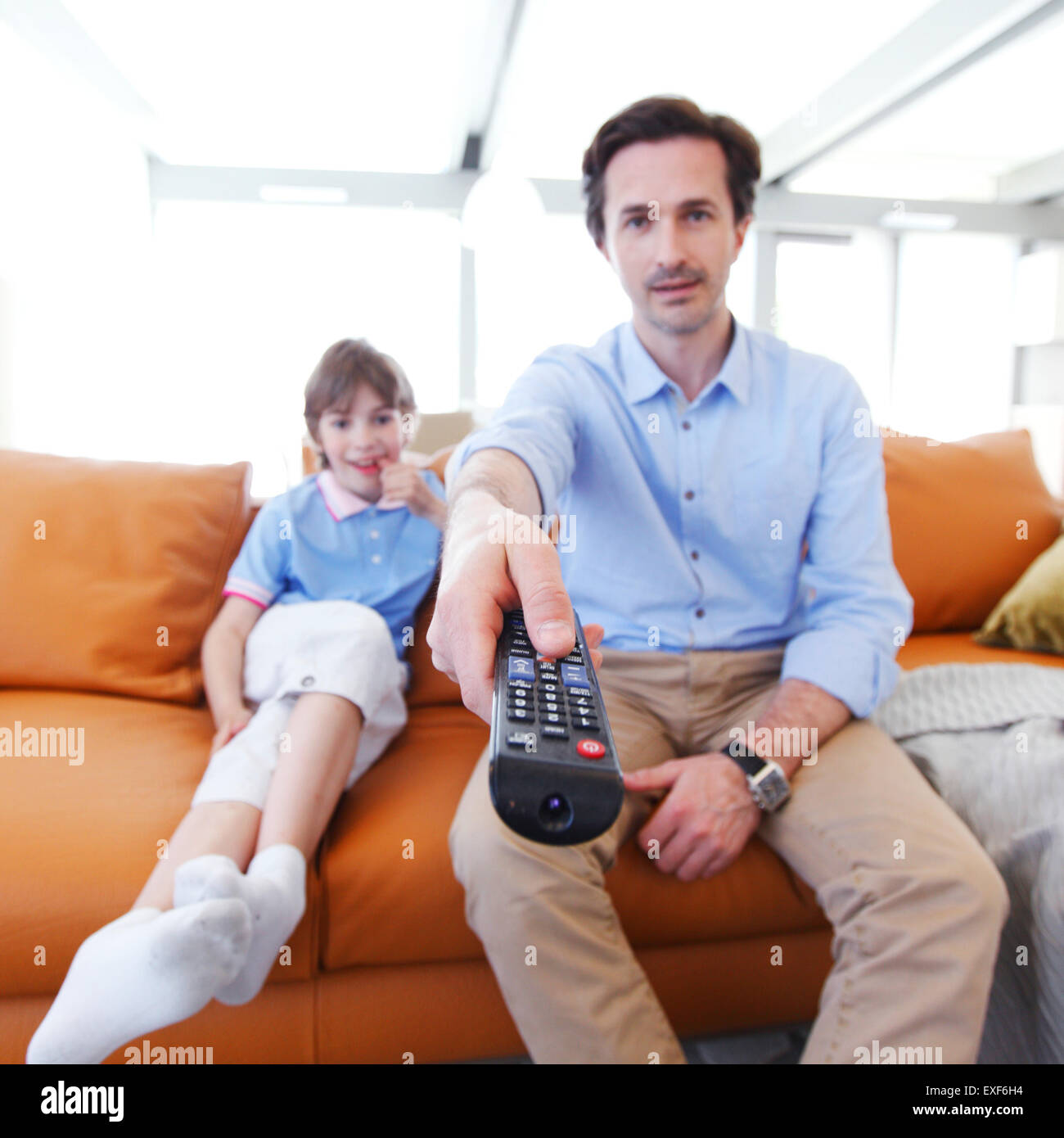 father and son watching tv Stock Photo - Alamy