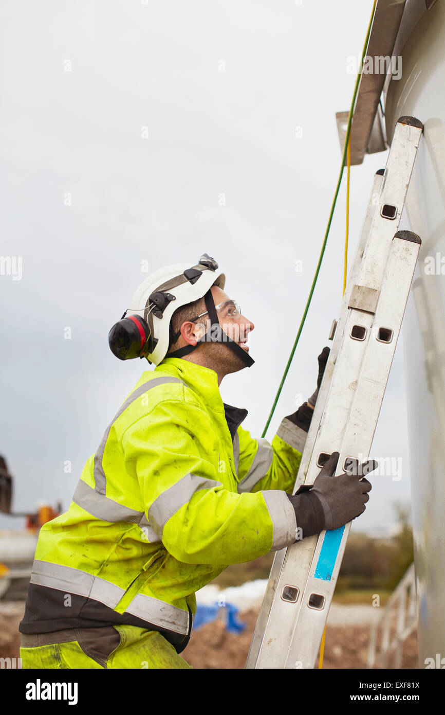 Engineer climbing ladder, working on wind turbine Stock Photo - Alamy