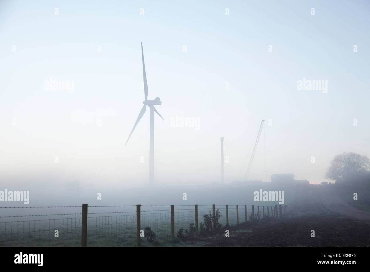Wind turbine in mist Stock Photo - Alamy