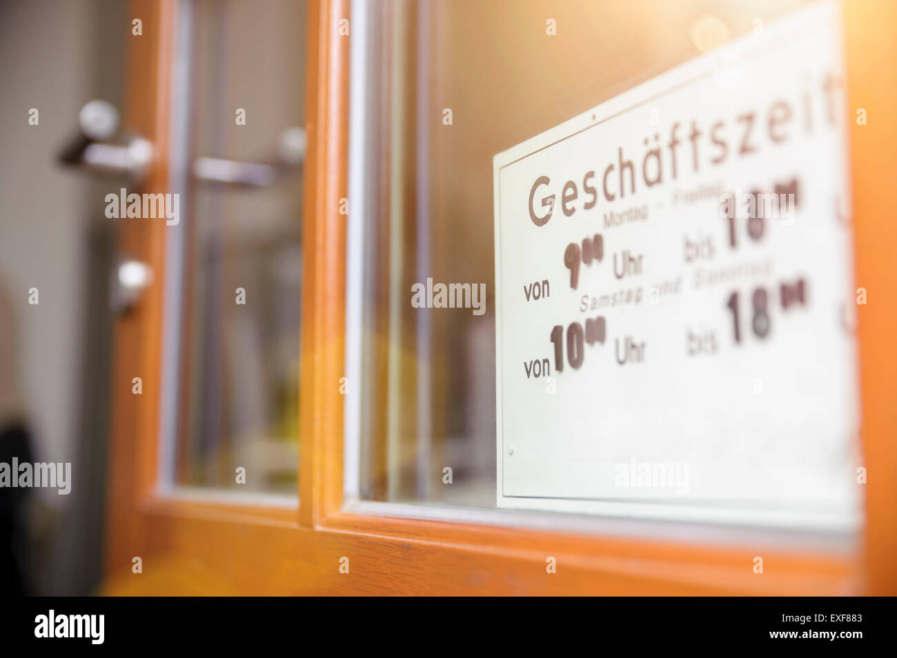 Opening hours sign on door of cafe Stock Photo - Alamy