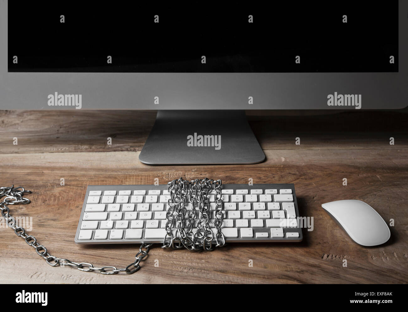 Computer monitor and keyboard, chains wrapped around keyboard Stock ...