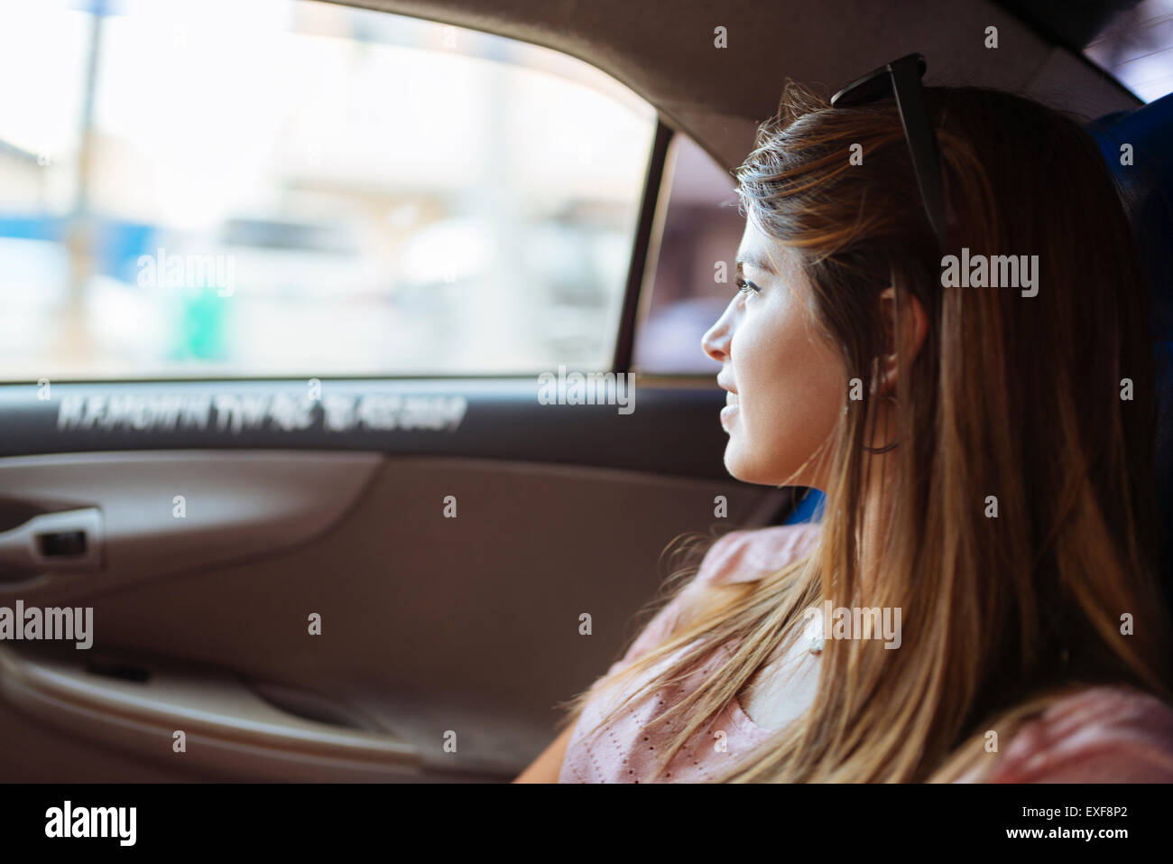 Young woman looking out of taxi window, Manila, Philippines Stock Photo ...