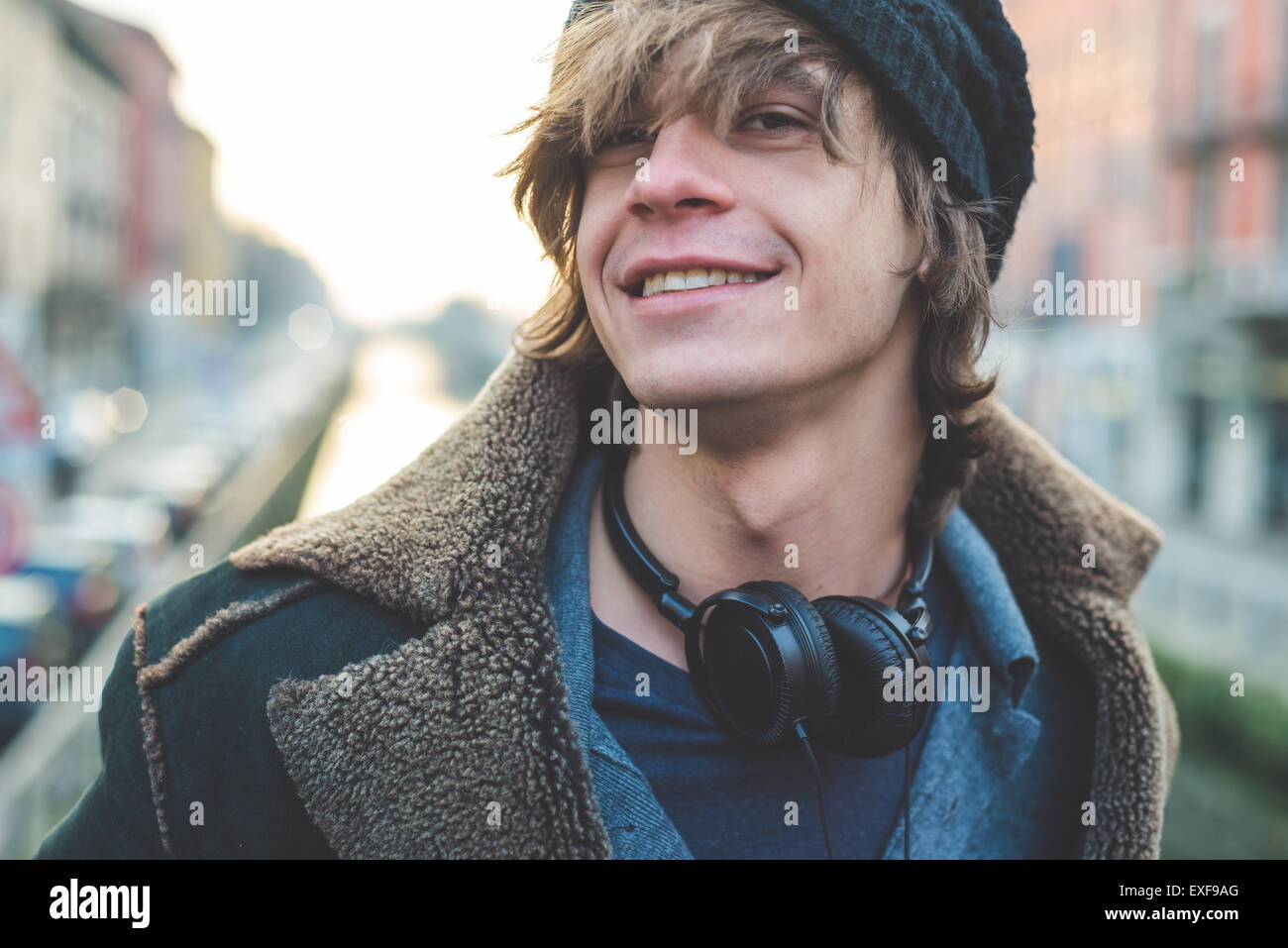 Man with headphones hung around neck Stock Photo - Alamy