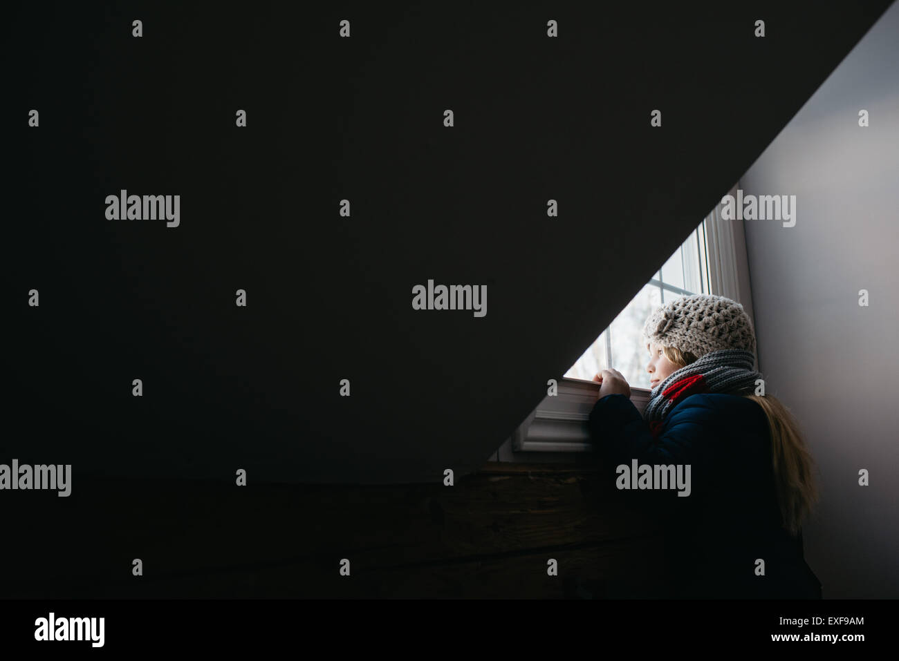 Girl looking out of window Stock Photo - Alamy