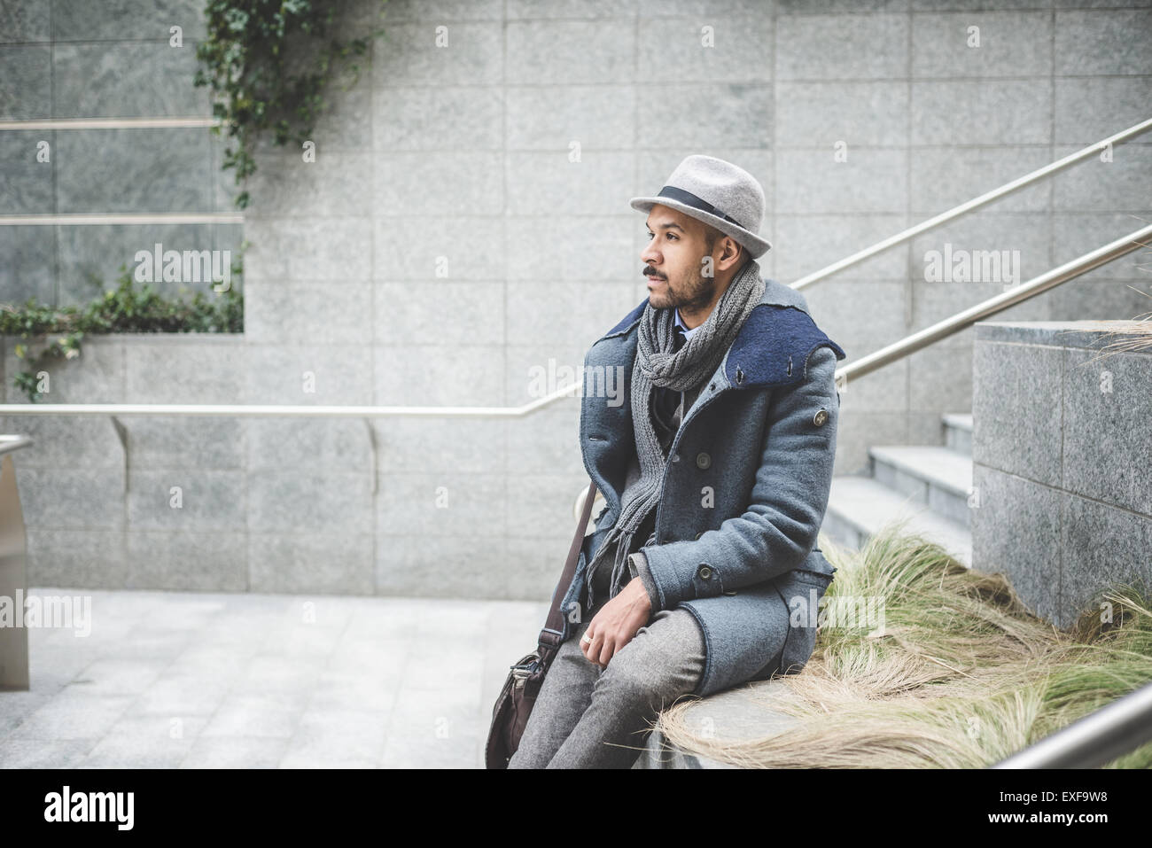 Businessman sitting on wall hi-res stock photography and images - Alamy