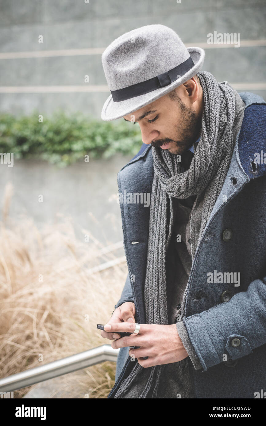 Mid adult businessman standing on stairway reading text message Stock ...