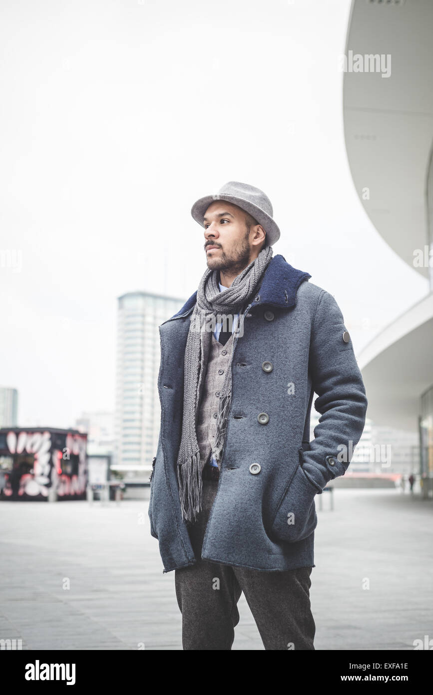 Businessman waiting outside office building Stock Photo - Alamy