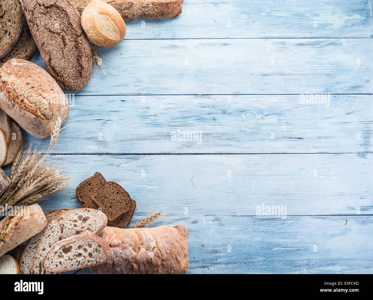 The bread and a wheat on the wooden desk Stock Photo - Alamy