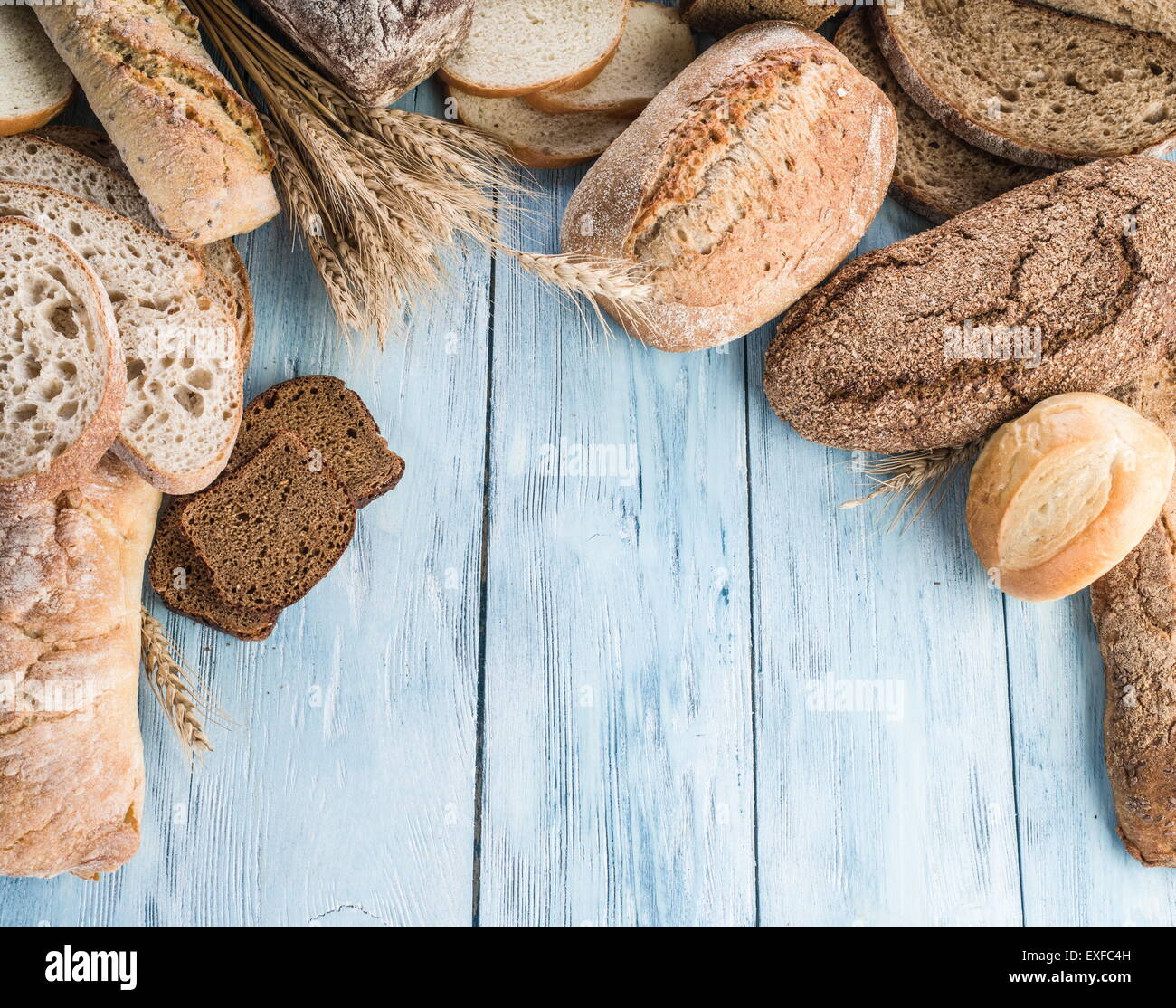 The bread and a wheat on the wooden desk Stock Photo - Alamy