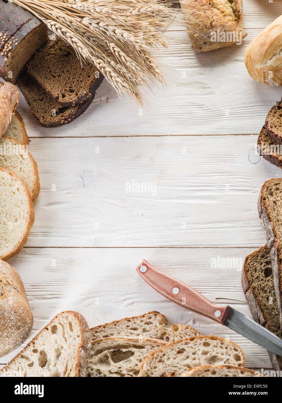 The bread and a wheat on the wooden desk Stock Photo - Alamy