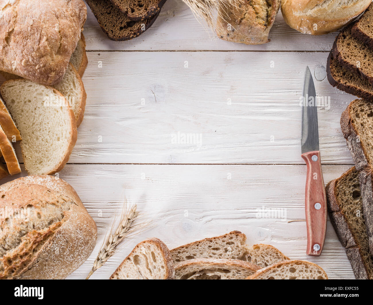 The bread and a wheat on the wooden desk Stock Photo - Alamy