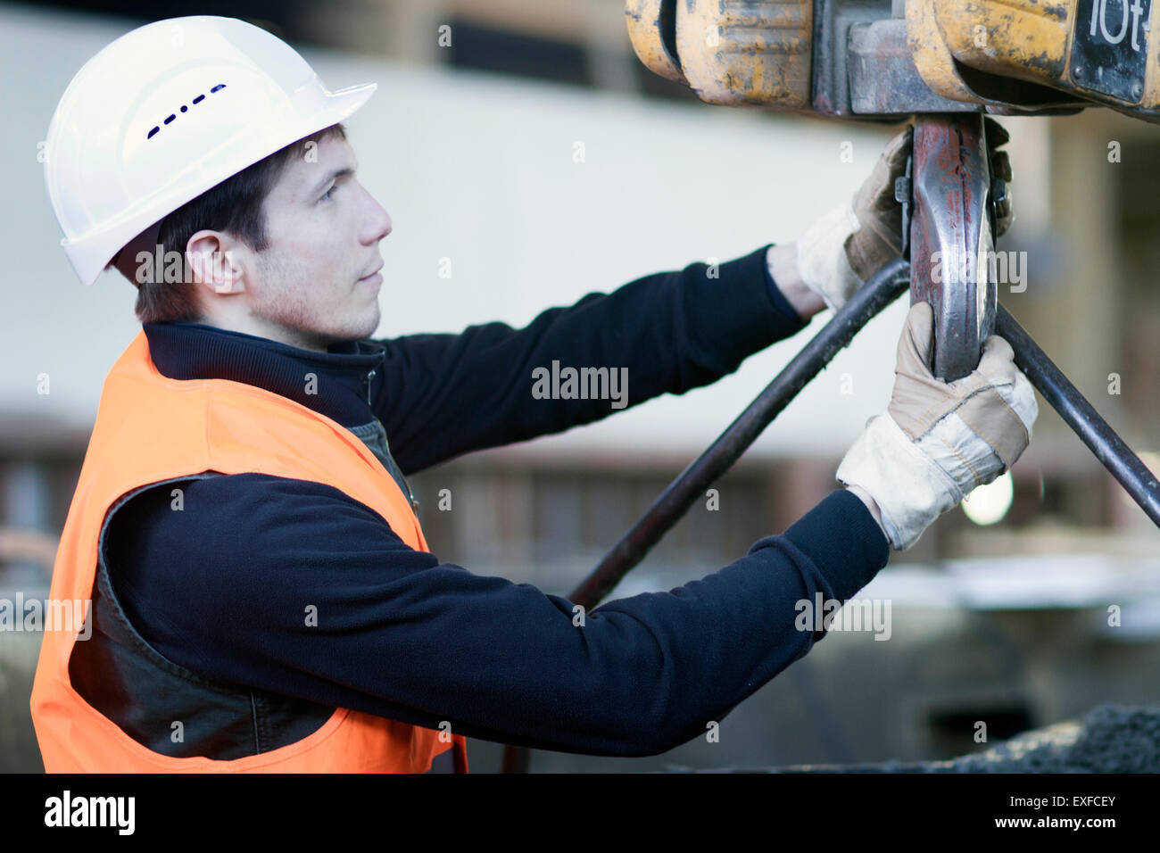 Factory worker attaching winch in concrete reinforcement factory Stock ...