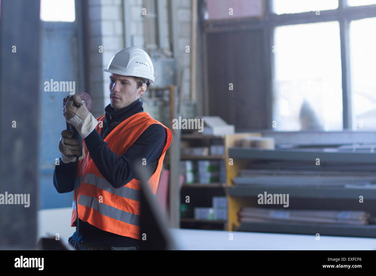 Factory worker checking component in concrete reinforcement factory ...
