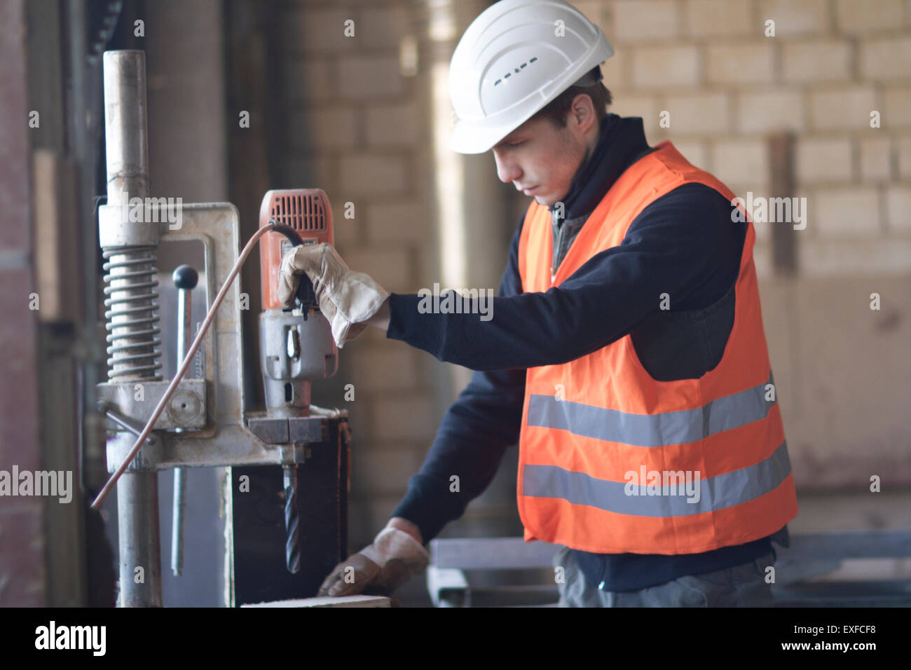 Factory worker using drill in concrete reinforcement factory Stock ...