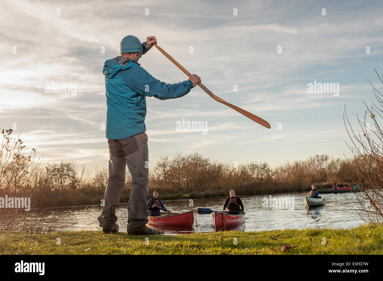 Mature man demonstrating using an oar Stock Photo - Alamy