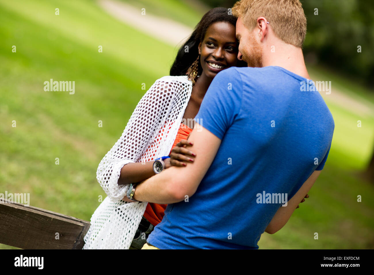 Multiracial couple in the park Stock Photo - Alamy