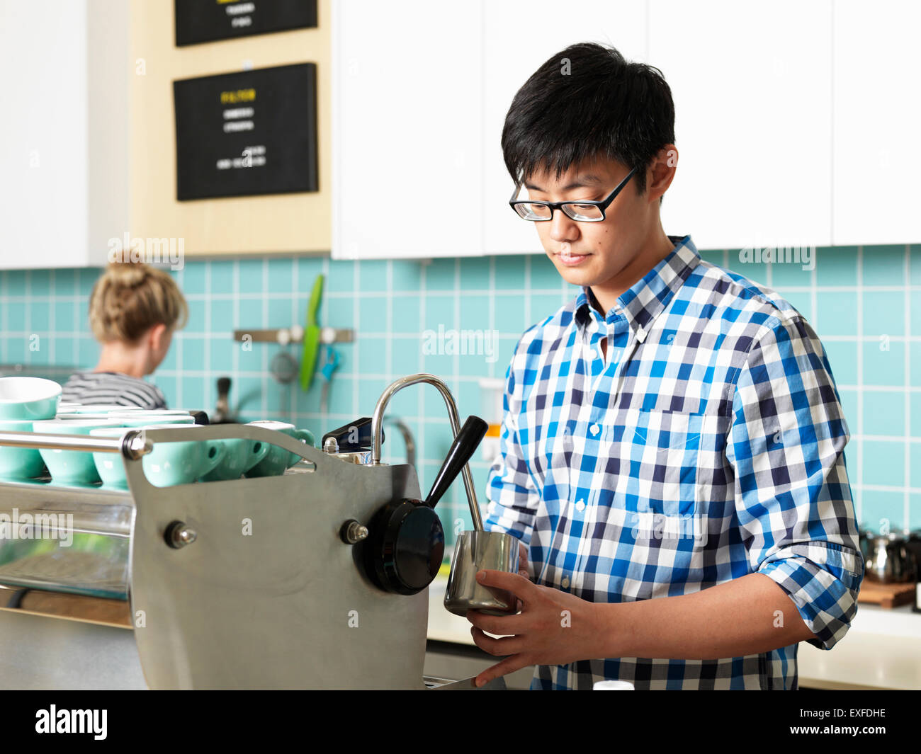 Staff working behind coffee bar Stock Photo - Alamy