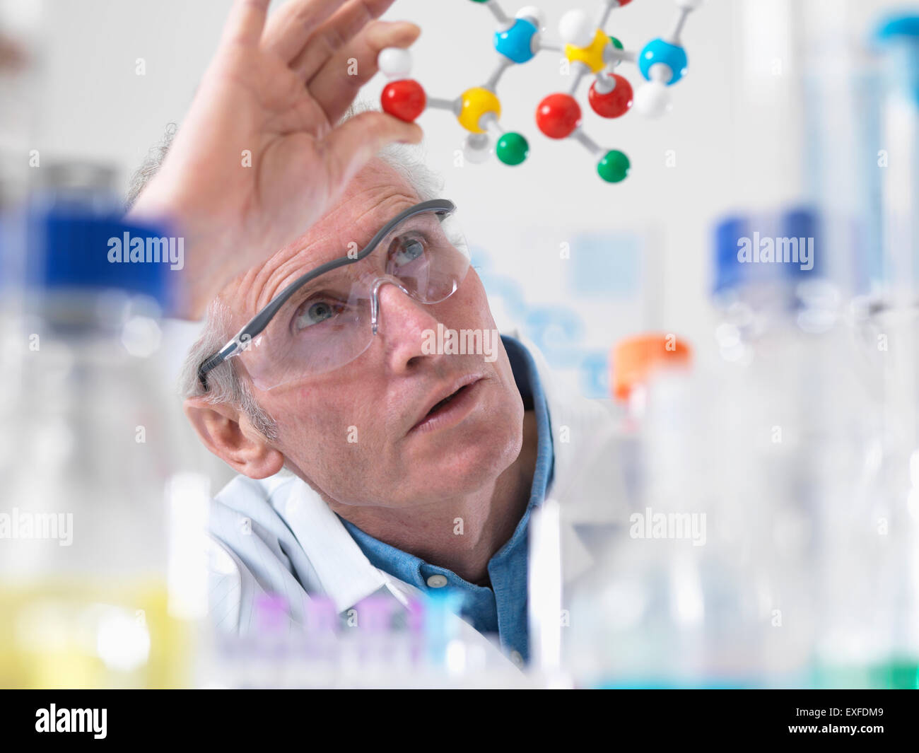 Scientist viewing molecular model of a chemical formula in a laboratory ...