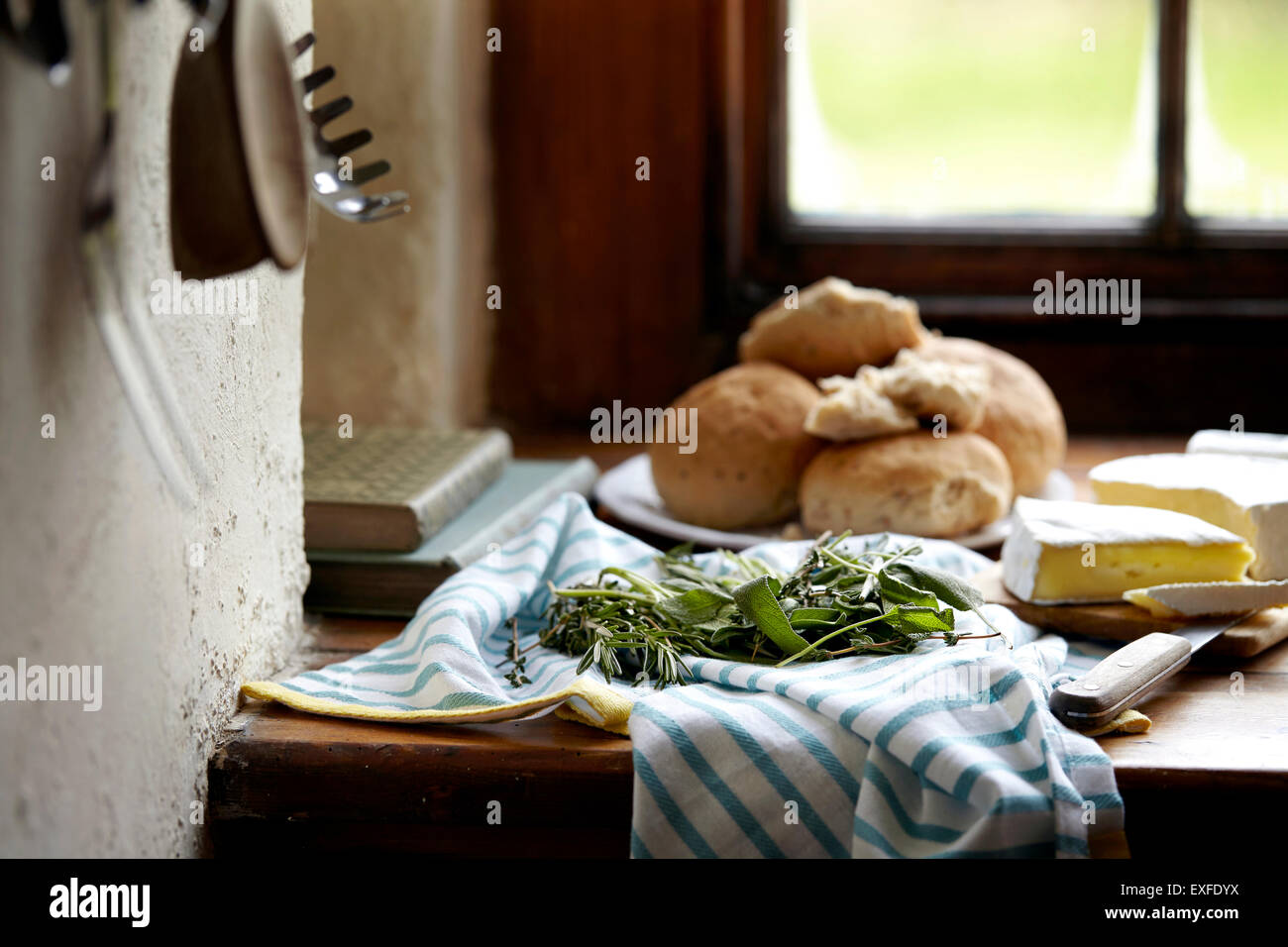 Bread rolls and brie on kitchen counter Stock Photo - Alamy