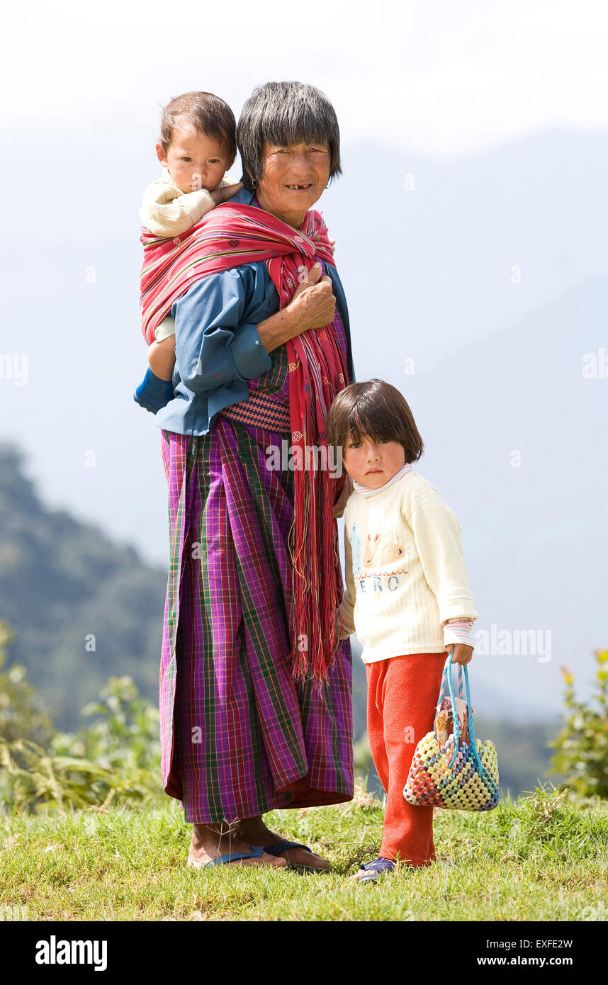 Portrait of Bhutanese woman and two children on hill, Timpu, Bhutan ...