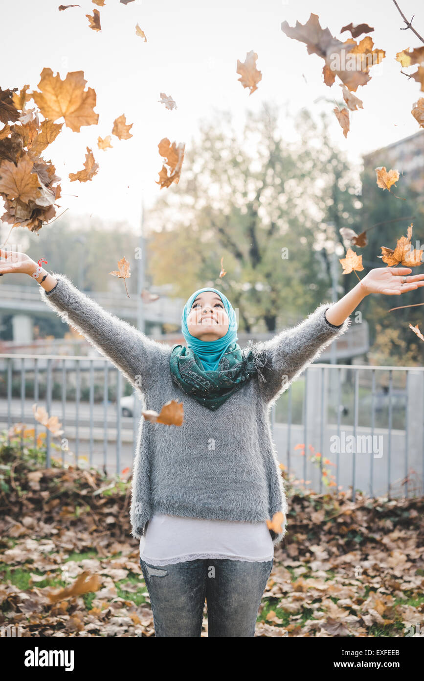 Woman throwing leaves in the air hi-res stock photography and images ...
