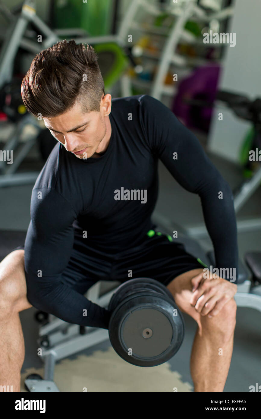 Young man training in the gym Stock Photo - Alamy
