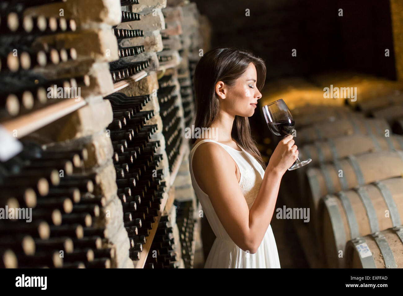 Young woman in the wine cellar Stock Photo - Alamy