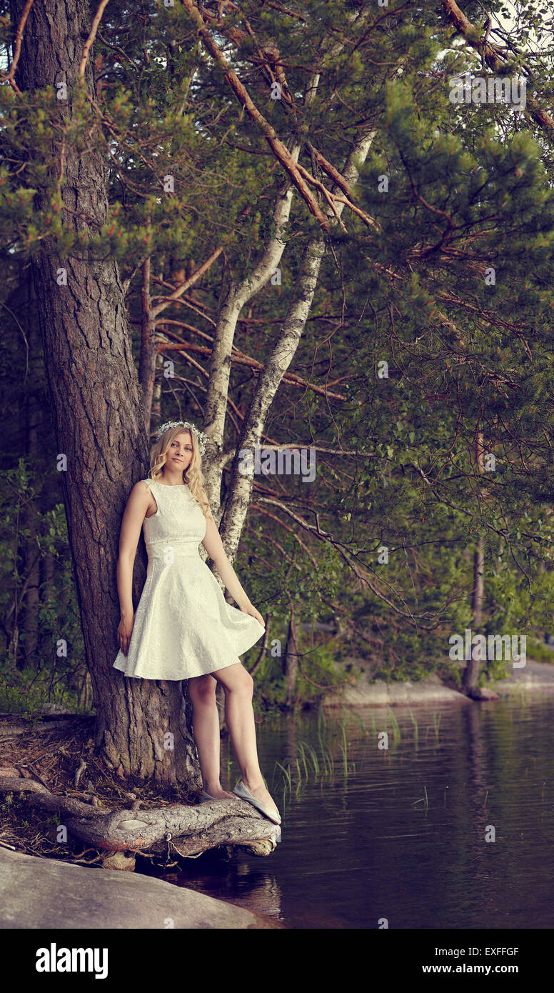 Attractive Young Woman Wearing White Summer Dress And She Leans Towards