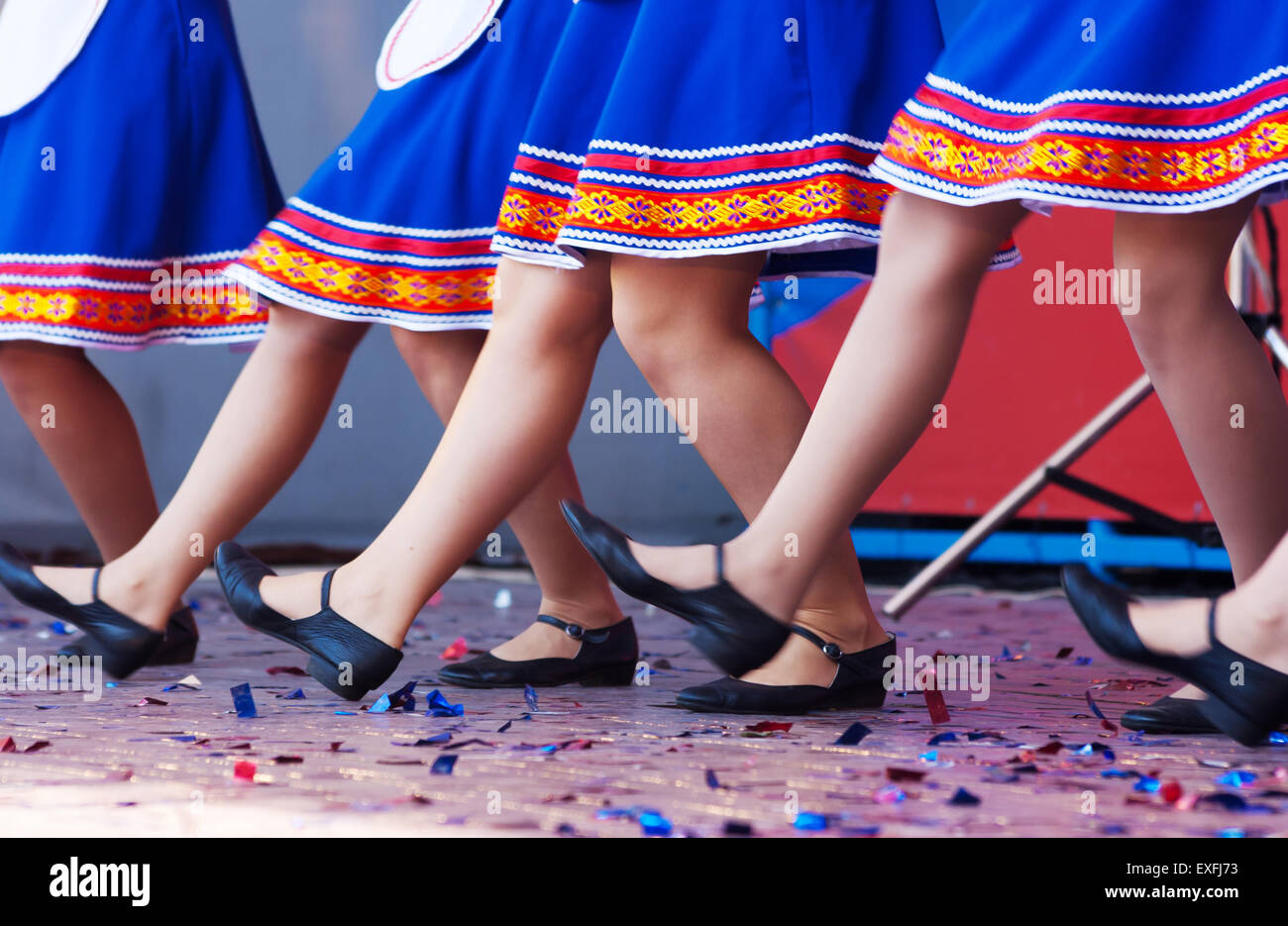 russian girls in traditional costumes dancing on stage. legs closeup ...