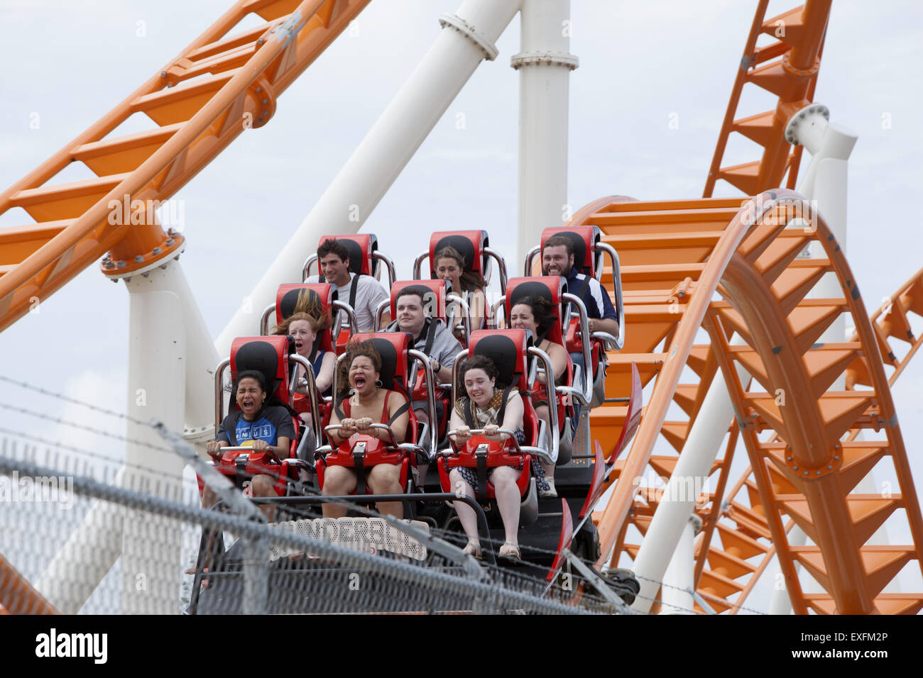 People ride the hair raising Thunderbolt roller coaster by the beach at ...