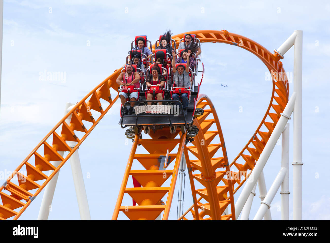 People ride the hair raising Thunderbolt roller coaster by the beach at ...