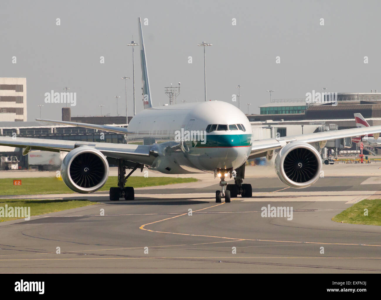 Cathay Pacific Boeing 777 taxiing on Manchester Airport taxiway Stock ...