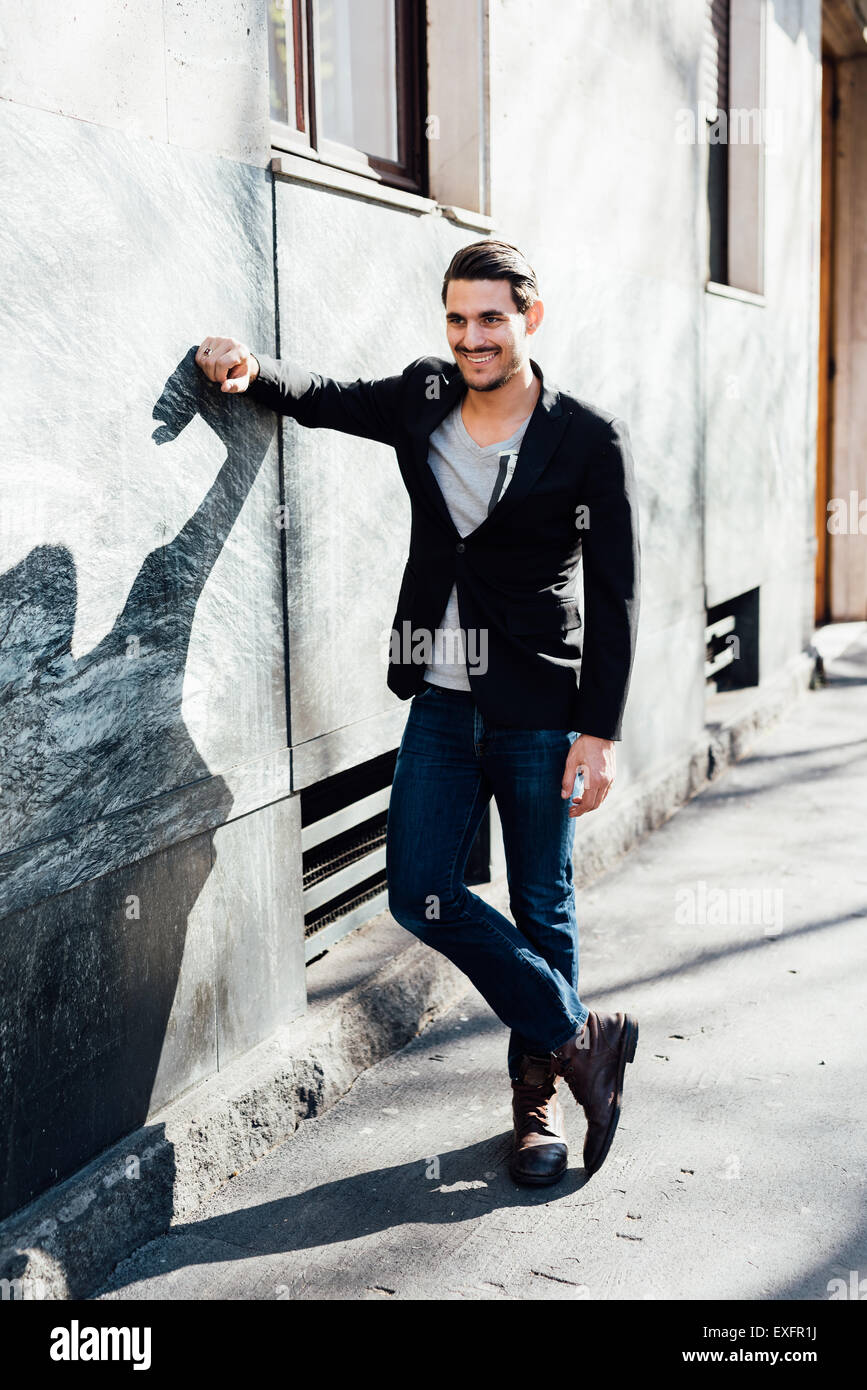 Young handsome italian boy posing leaning on a wall in the city Stock ...