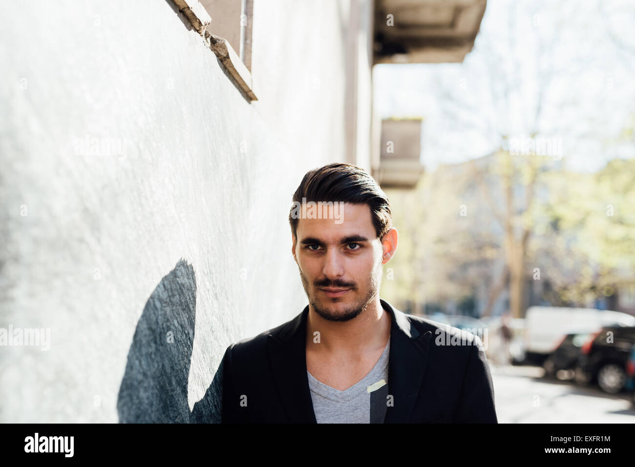 Portrait of a young handsome italian boy posing through the street of ...