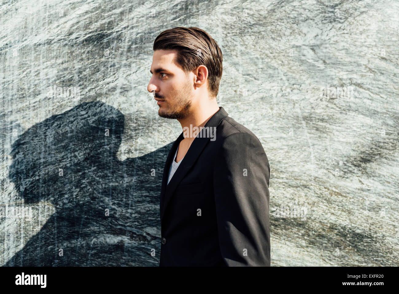 Portrait of a young handsome italian boy posing through the street of ...