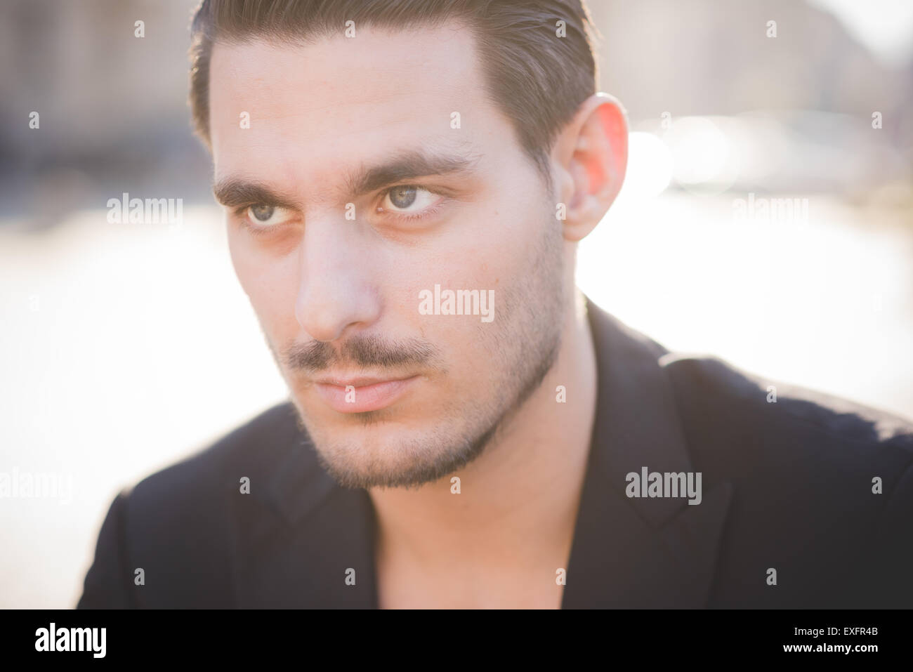 Portrait of a young italian boy posing through the street of the city ...