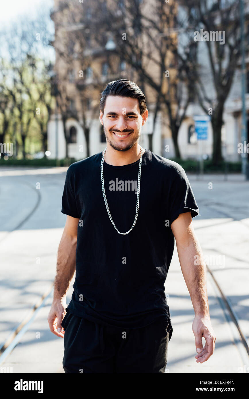 Young handsome italian boy walking through the streets of the city ...