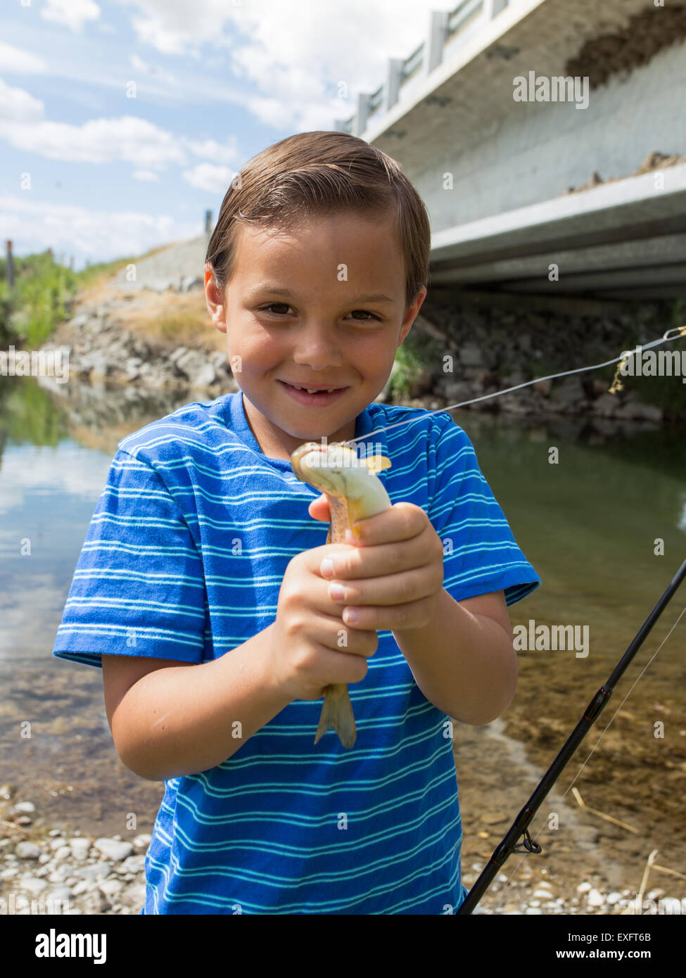 Young boy showing the fish he caught Stock Photo - Alamy